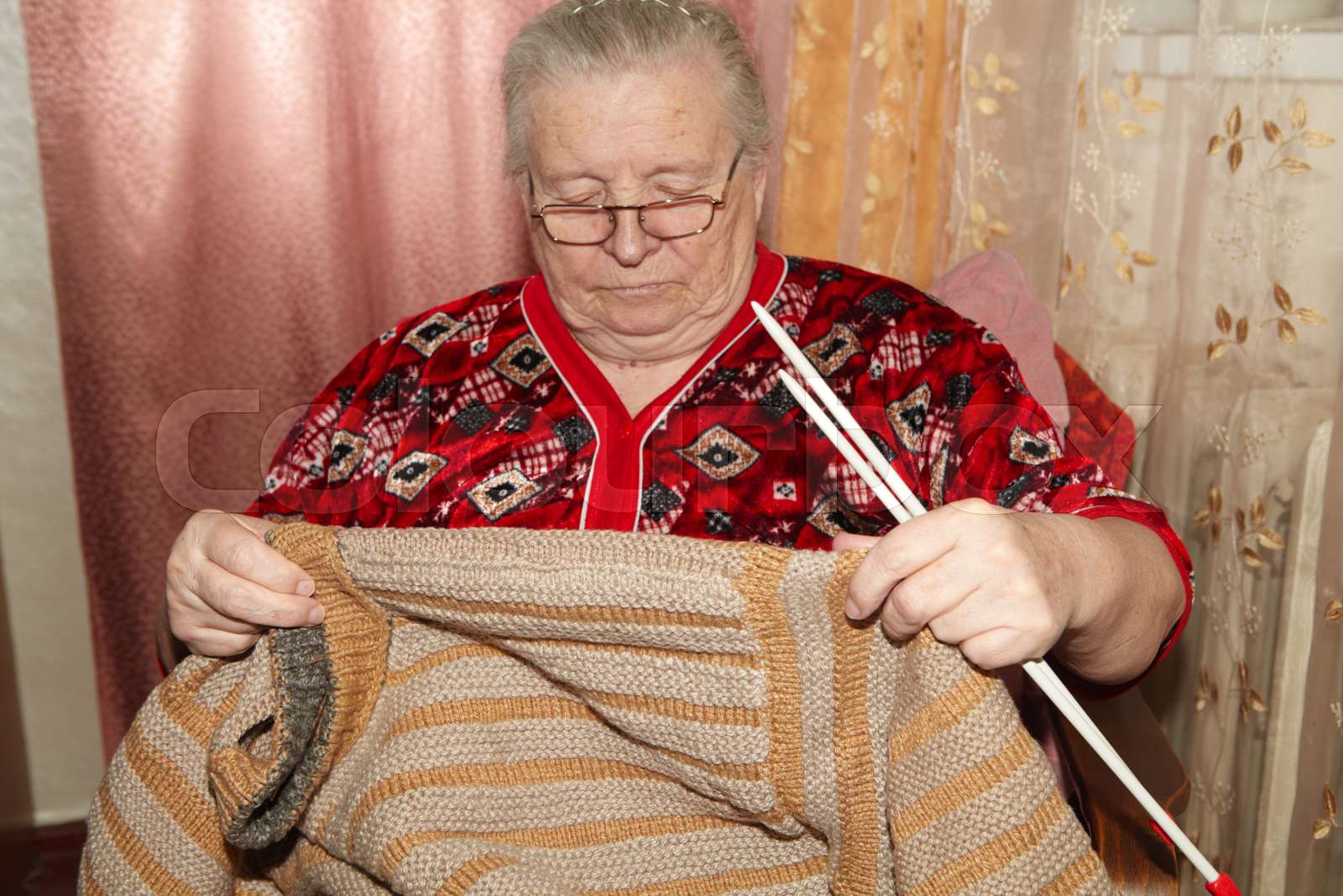 Old woman and knitting sweater | Stock image | Colourbox