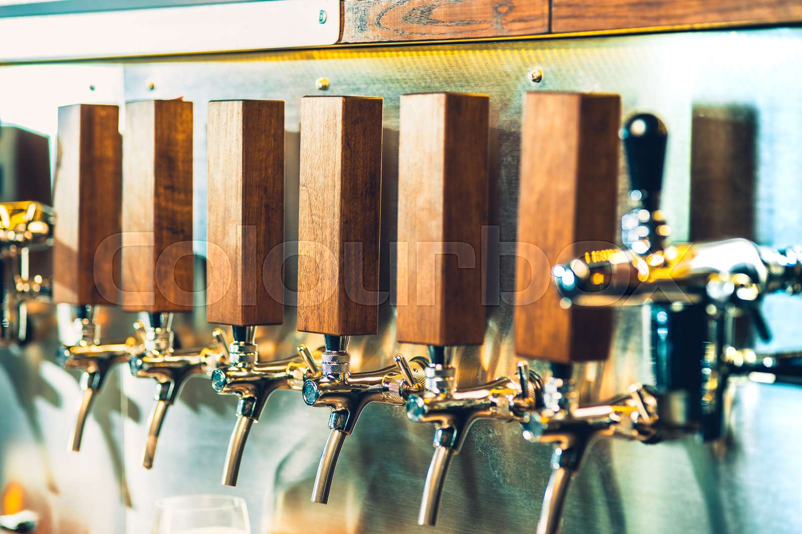 Beer taps in a pub | Stock image | Colourbox