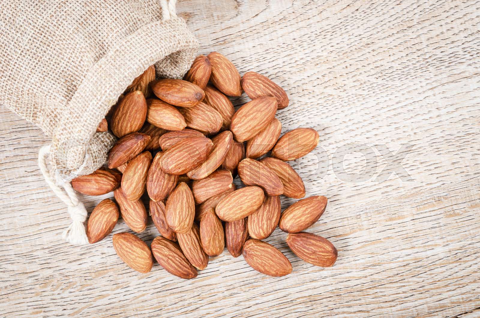 Almond seed on sack bag. | Stock image | Colourbox