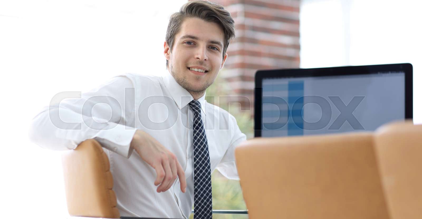 employee sitting in front of a computer screen | Stock image | Colourbox