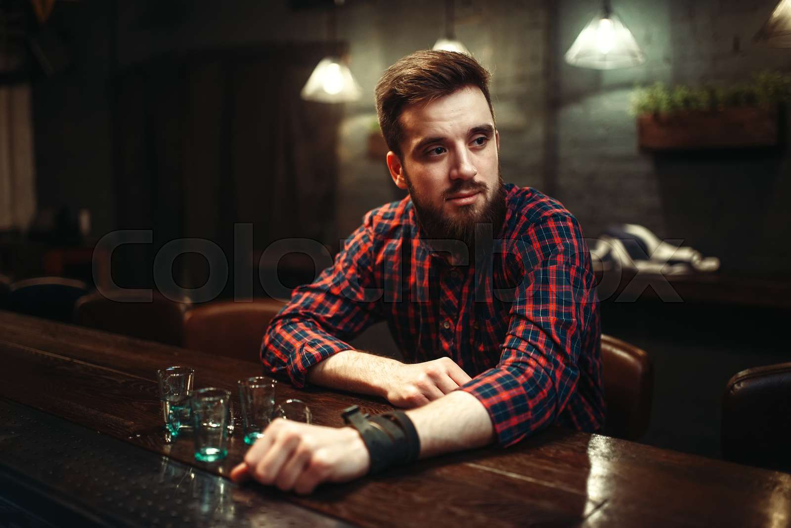 Sad man sitting at bar counter, alcohol addiction | Stock image | Colourbox