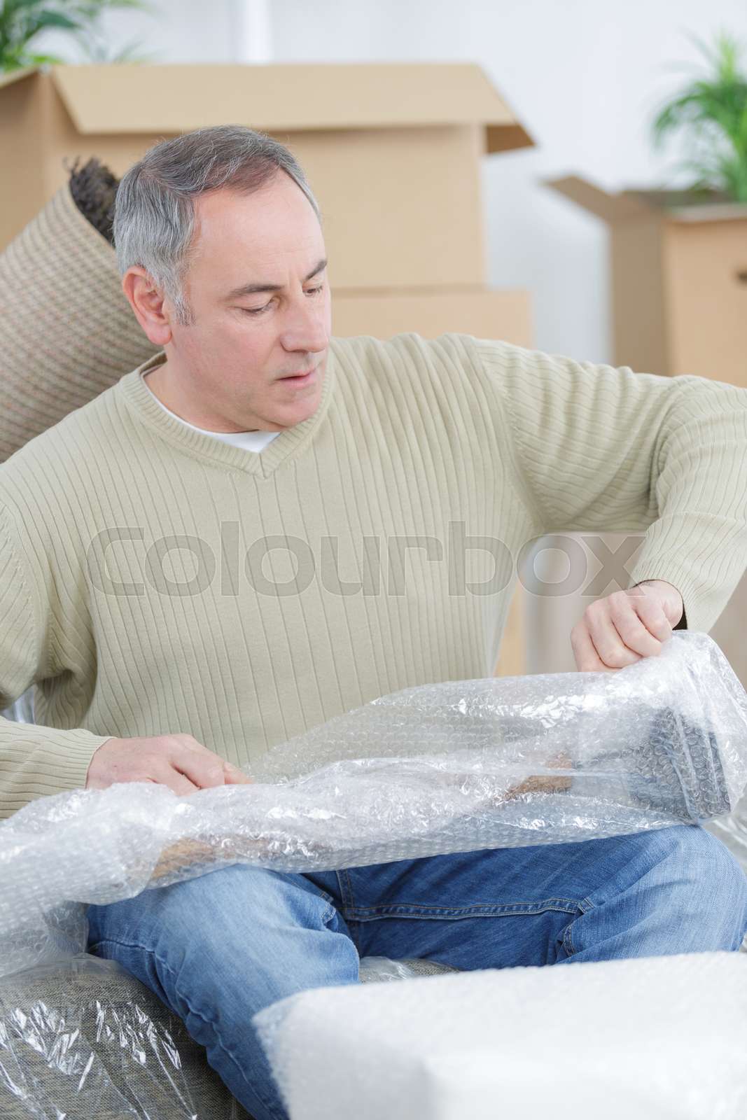 Man Unpacking Cartons In The New House Stock Image Colourbox