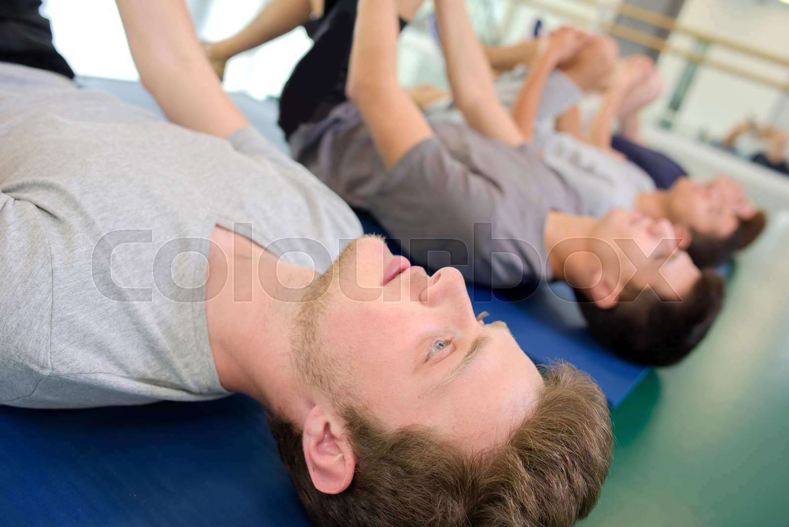 men lying on the mats | Stock image | Colourbox