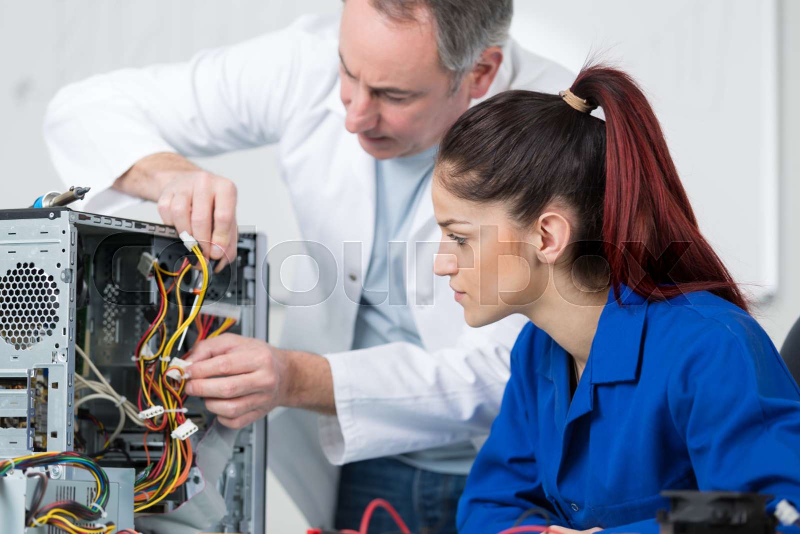 female students fixing a laptop | Stock image | Colourbox