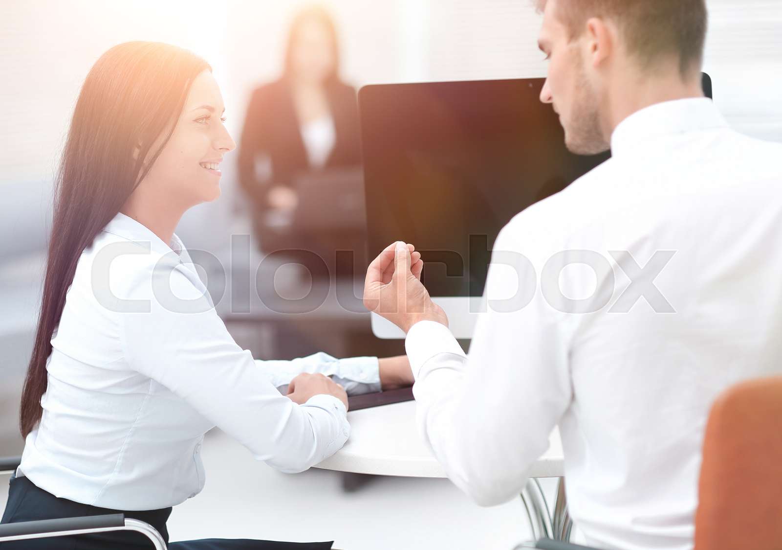 two successful employee talking sitting behind a Desk | Stock image ...