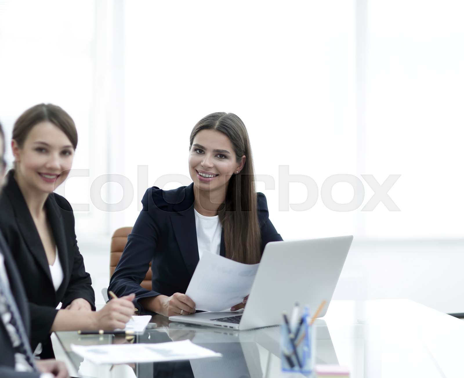 employees sitting behind a Desk. | Stock image | Colourbox