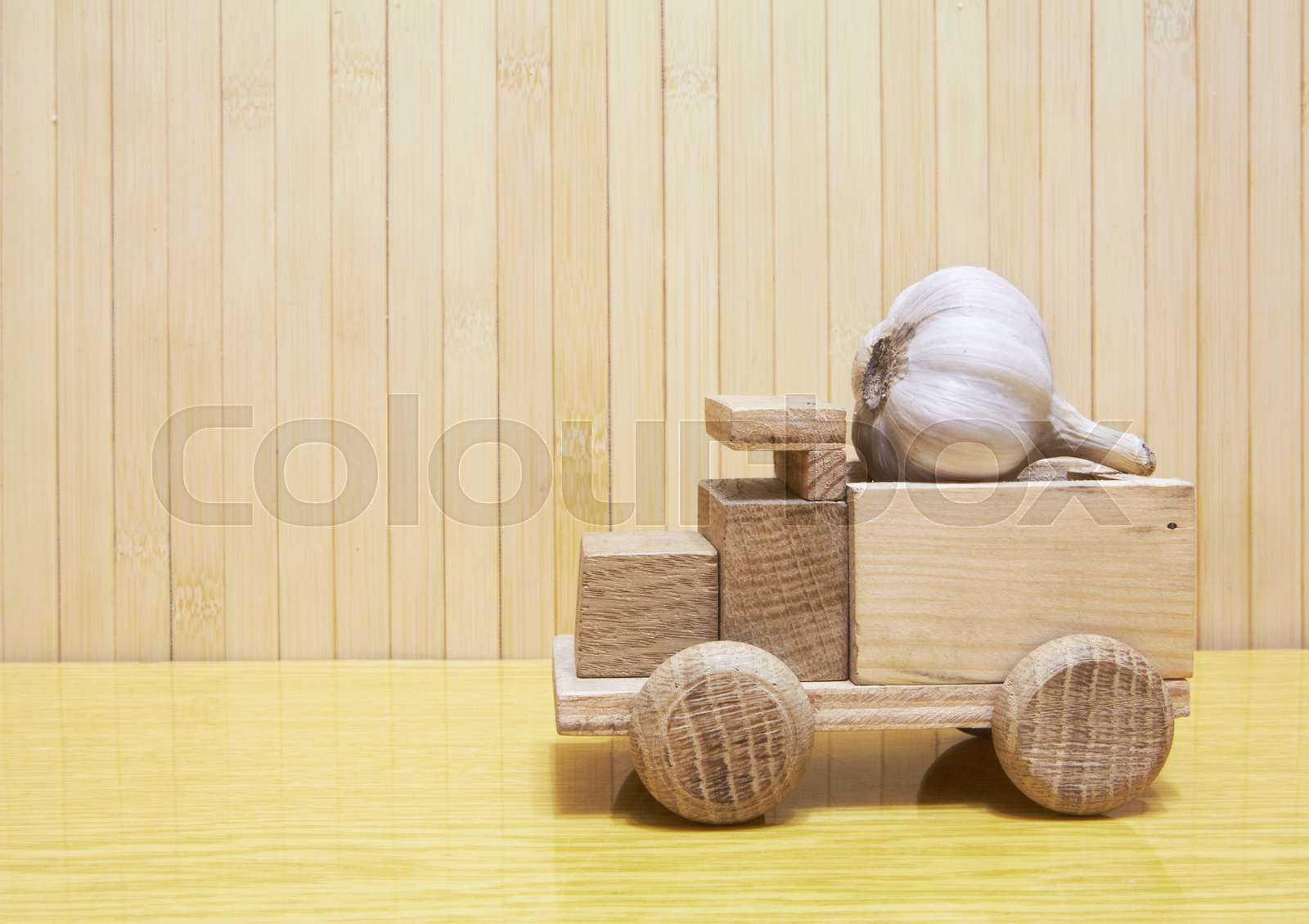 Toy wooden car with garlic | Stock image | Colourbox