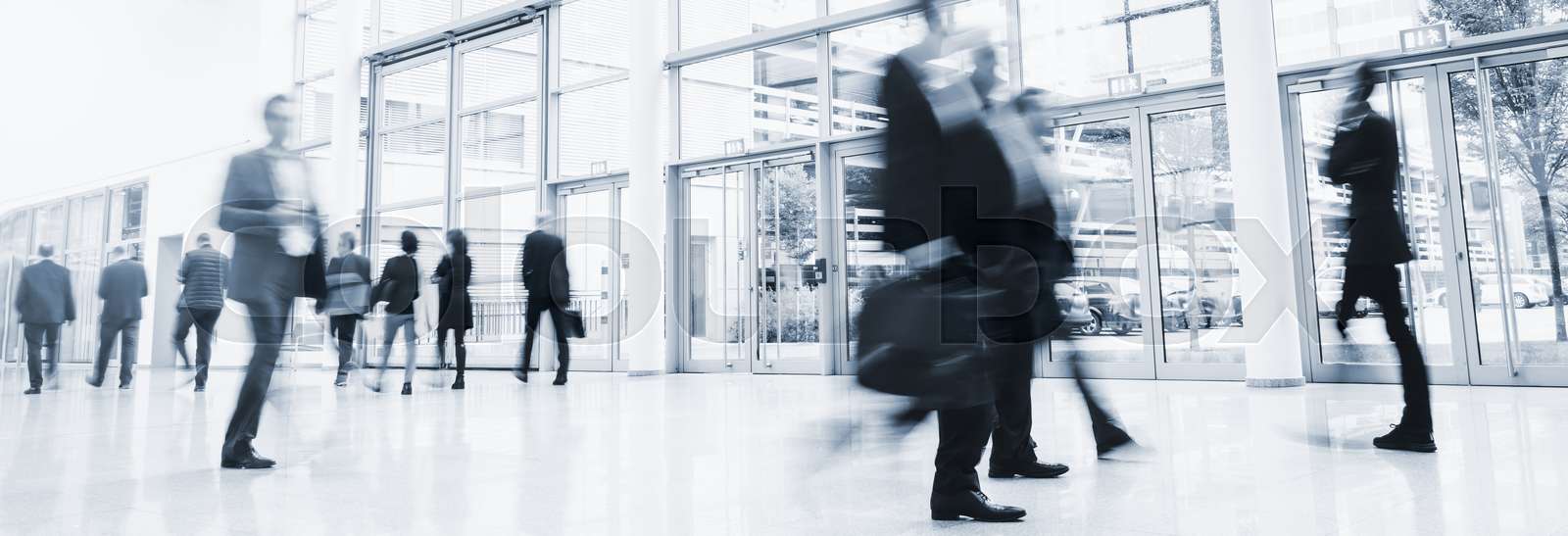 crowd of people walking against modern architecutre | Stock image ...