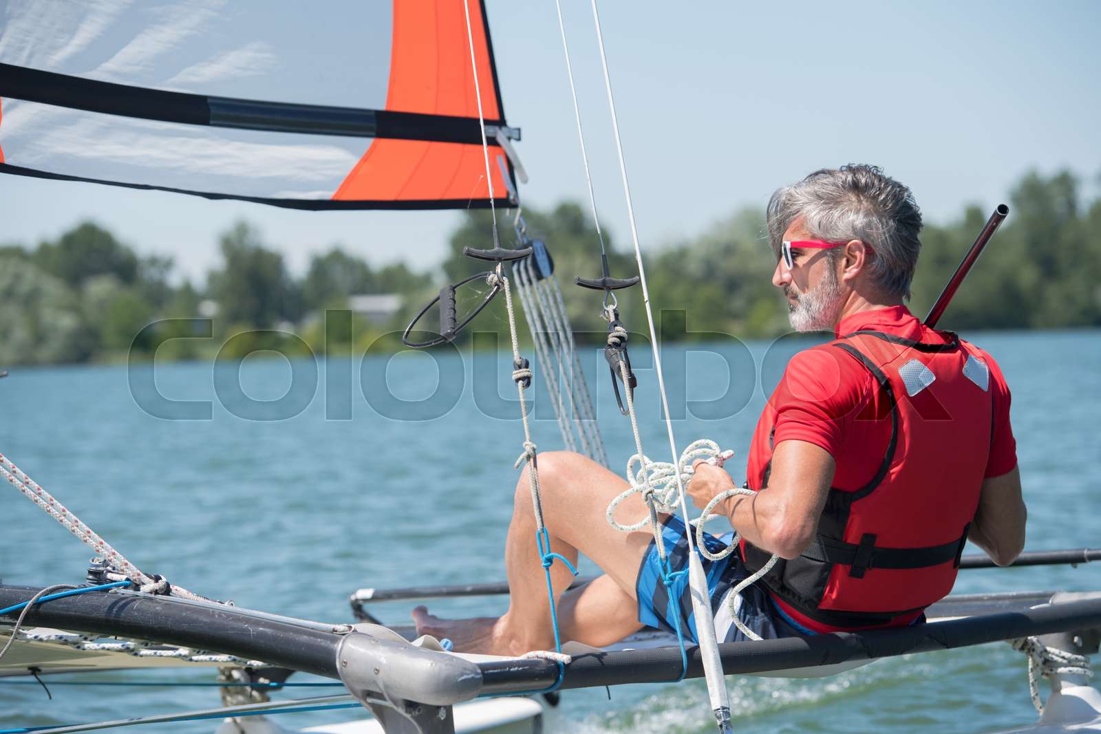 sailing man on sailboat during competition | Stock image | Colourbox