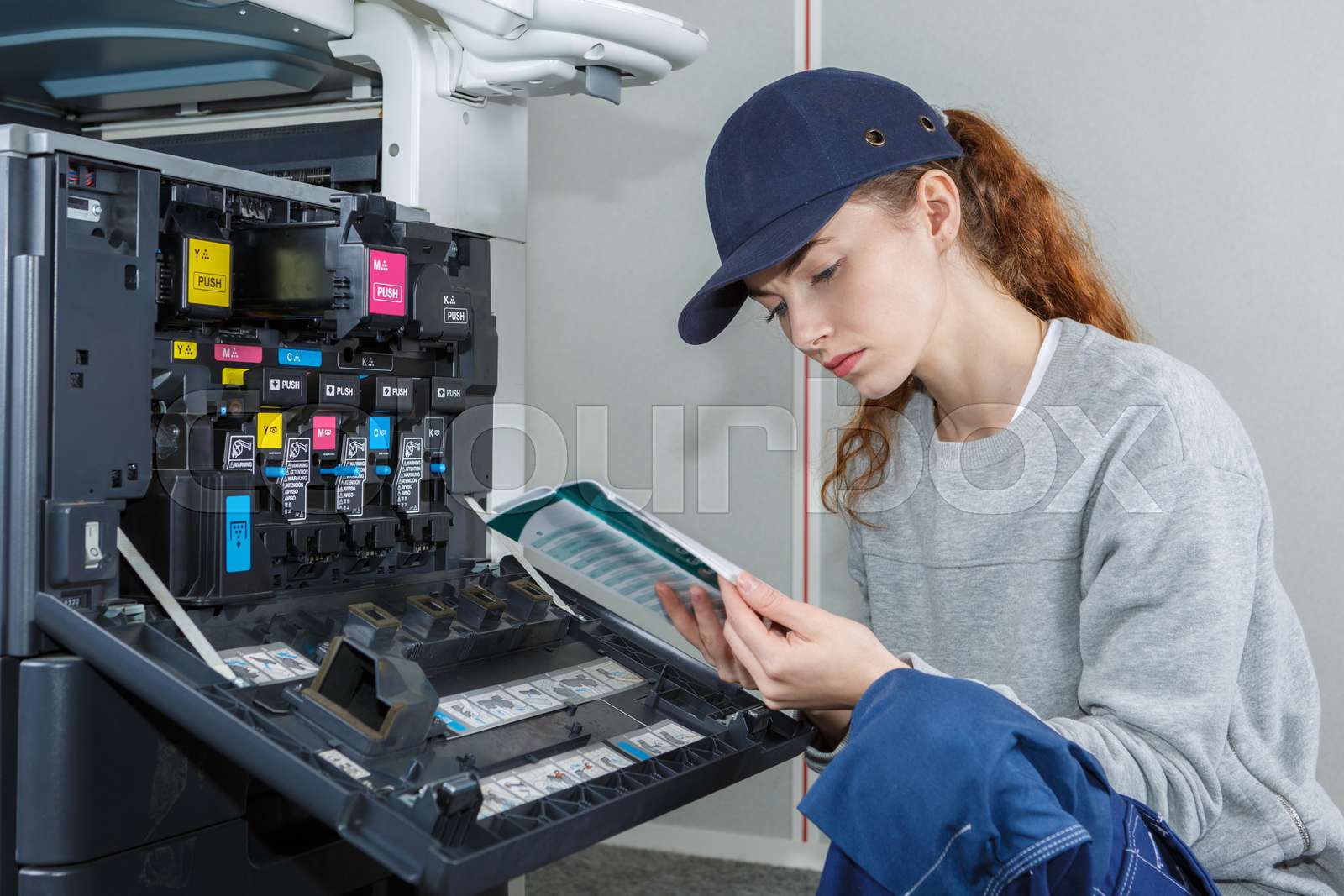 reading the printer manual and description guide | Stock image | Colourbox