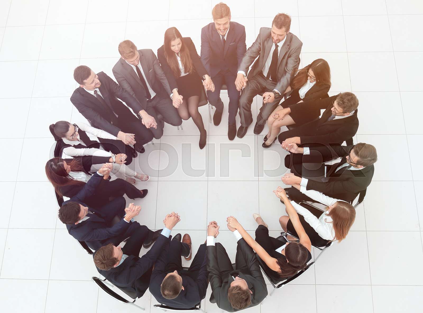 concept of team building.large business team sitting in a circle ...