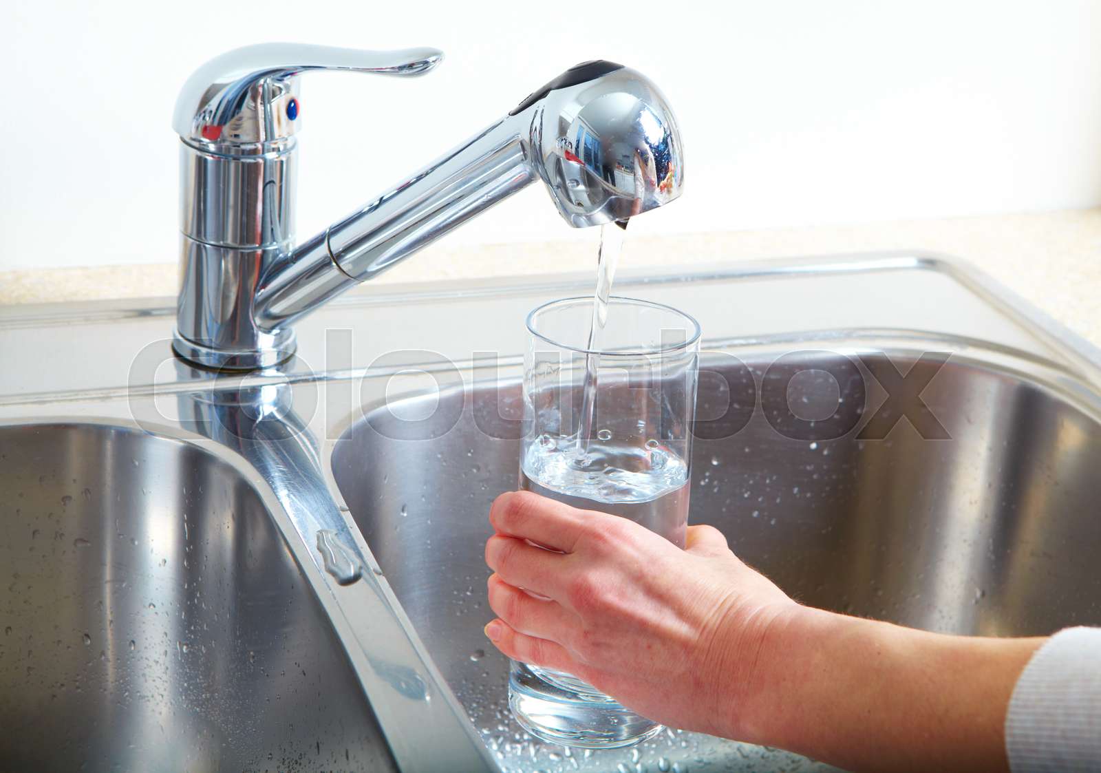 Filling glass of water | Stock image | Colourbox
