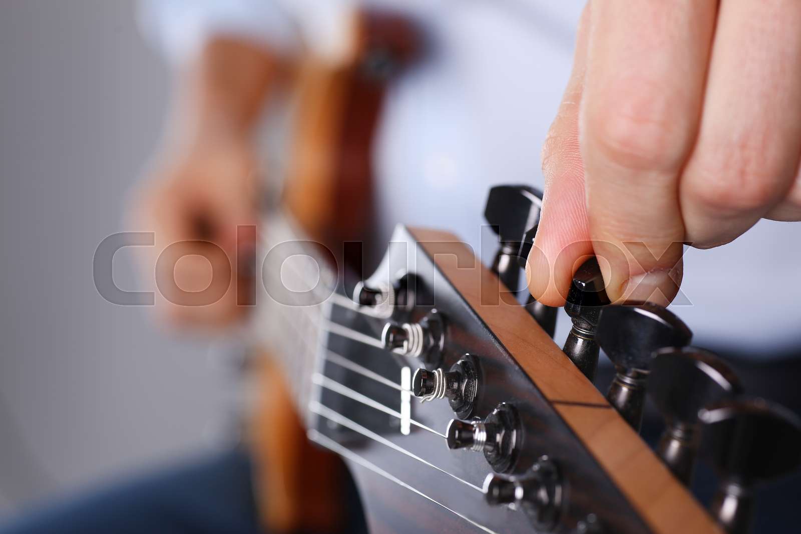 Male arms playing classic shape electric guitar | Stock image | Colourbox
