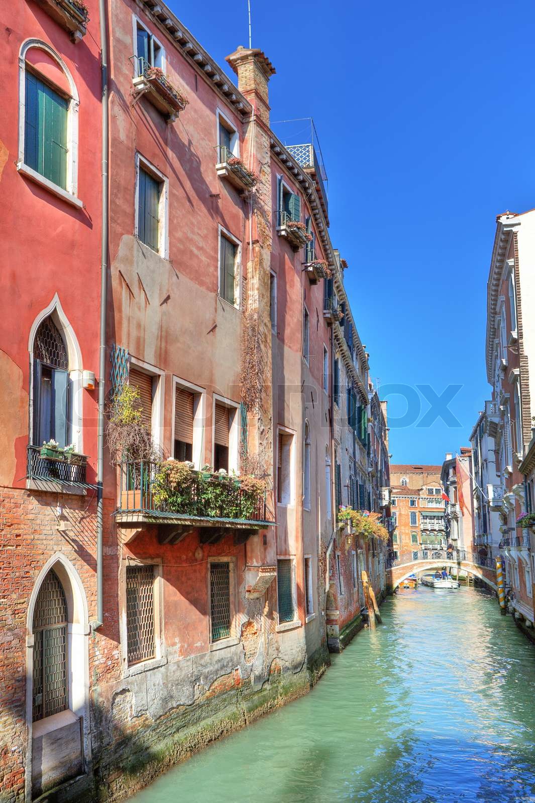 Vertical Oriented Image Of Small Narrow Canal Among Ancient Houses vertical-oriented-image-of-small-narrow-canal-among-ancient-houses