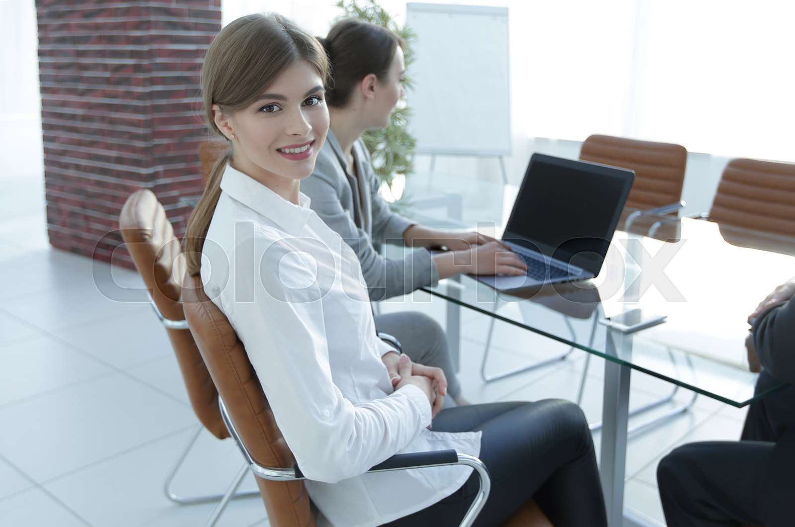 office workers sitting behind a Desk. | Stock image | Colourbox