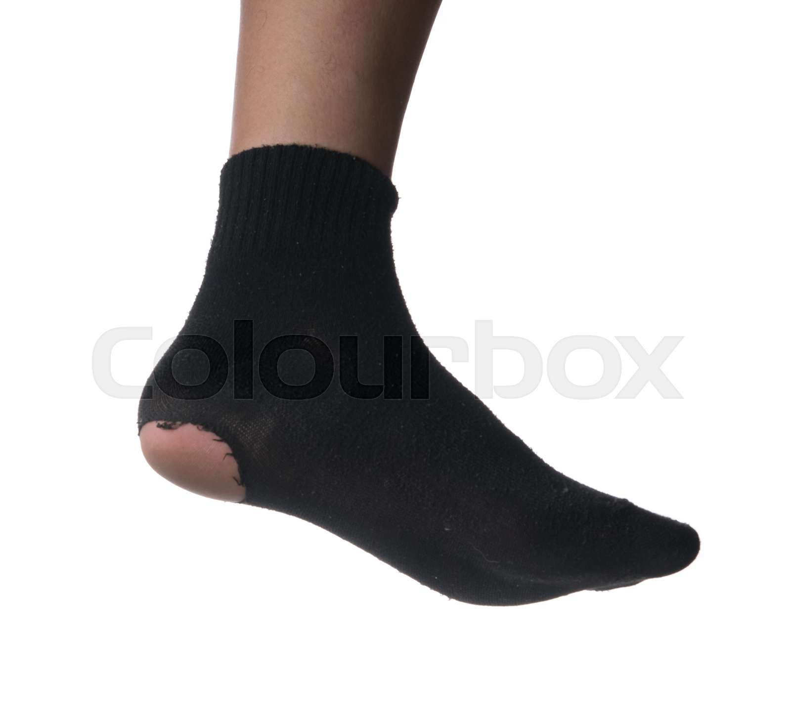 Black broken sock on male leg isolated on white | Stock image | Colourbox