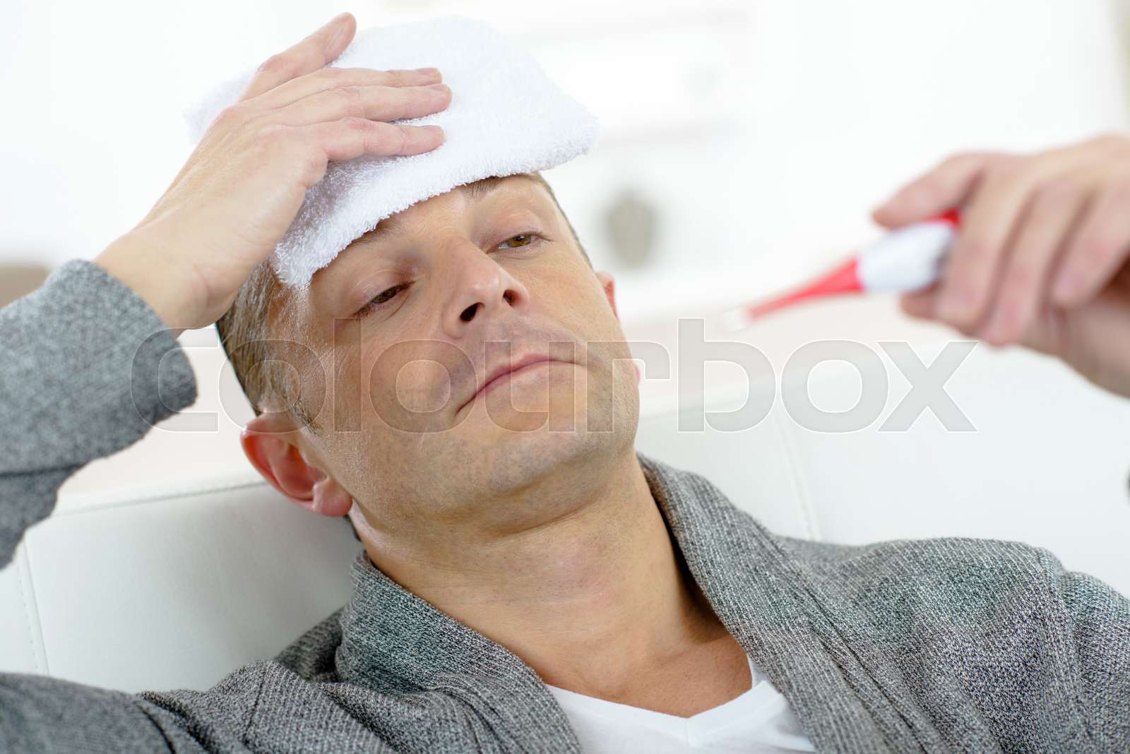 man checking his fever | Stock image | Colourbox