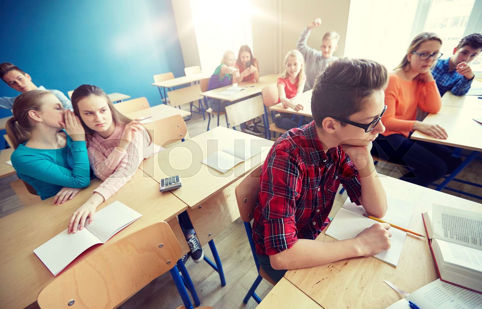 students gossiping behind classmate back at school | Stock image ...