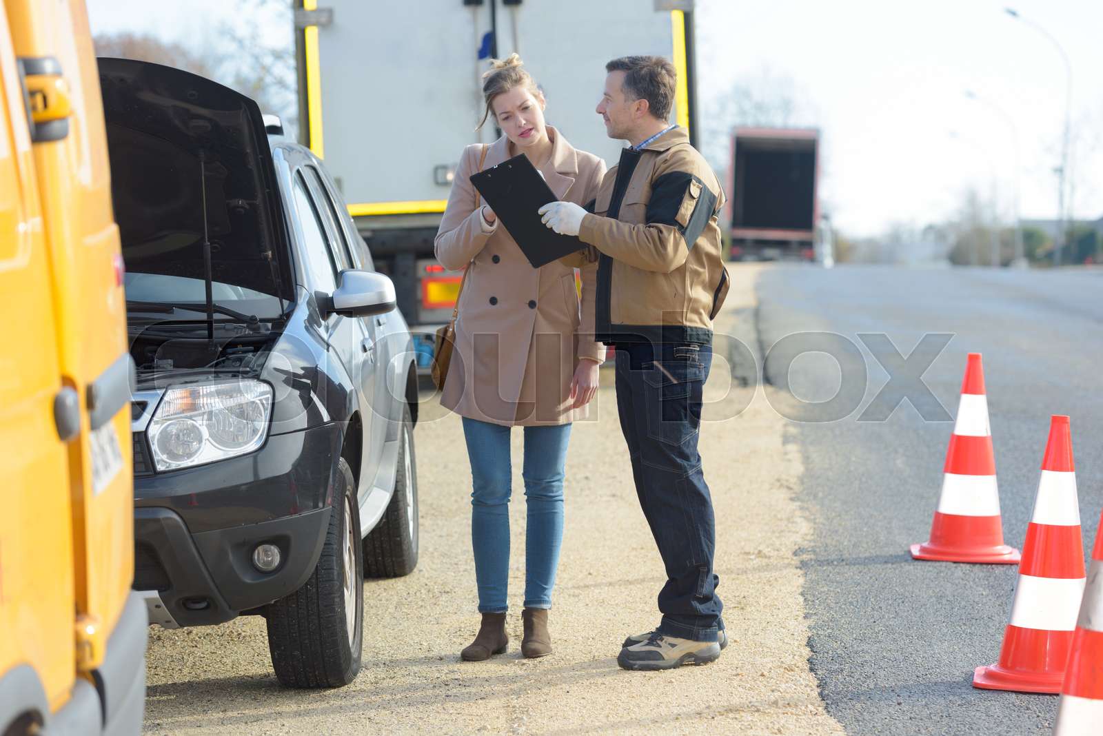 woman with recovery driver beside the road | Stock image | Colourbox