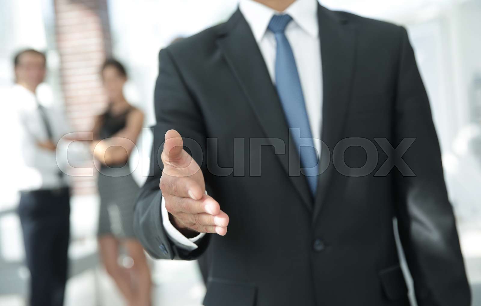 successful businessman giving a hand | Stock image | Colourbox