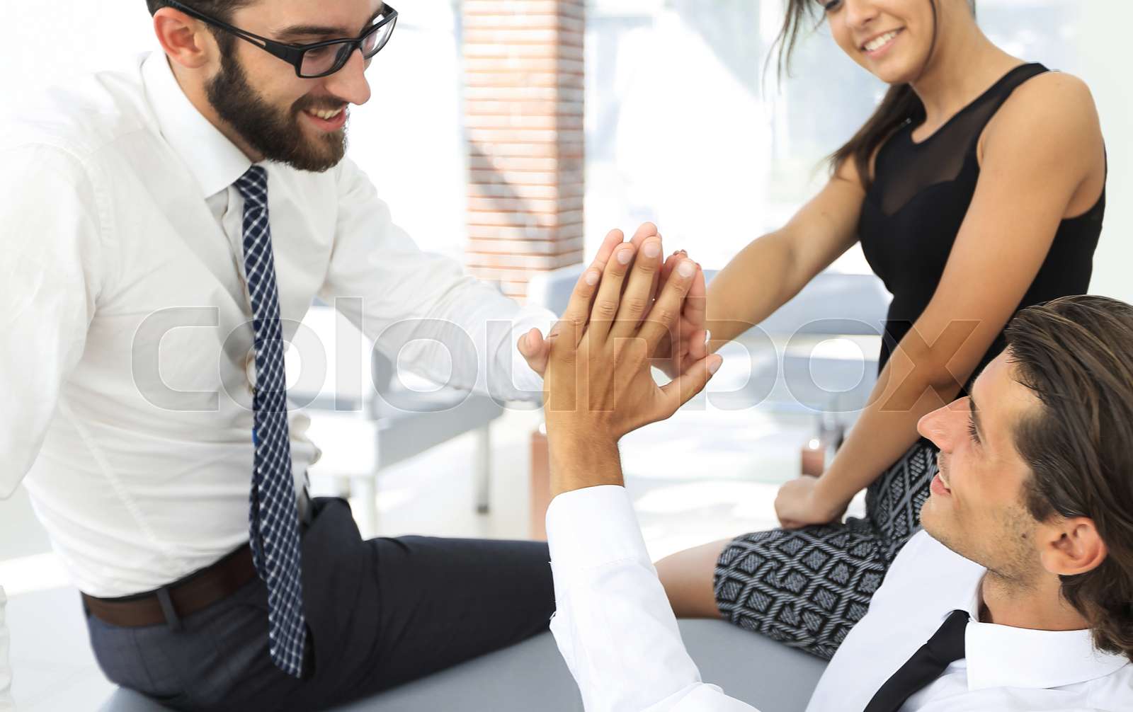 members of the business team give each other high five | Stock image ...