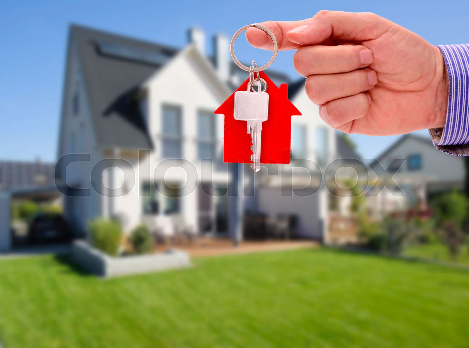 real estate agent offers a key for your new residential home | Stock ...