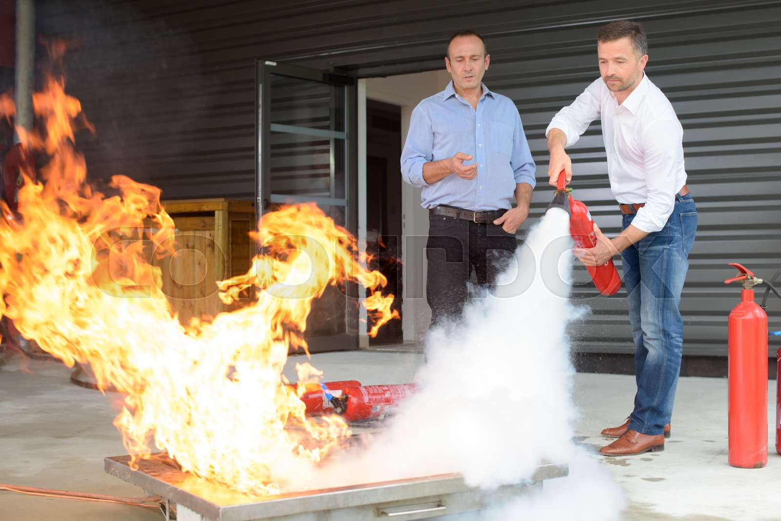 learning to use the fire extinguisher | Stock image | Colourbox