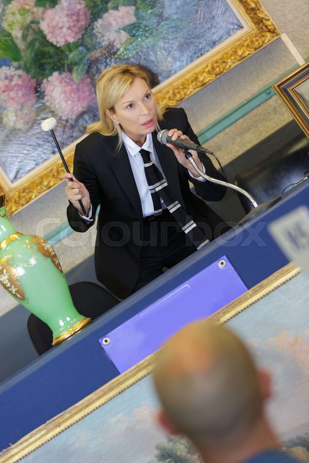female auctioneer during auction | Stock image | Colourbox