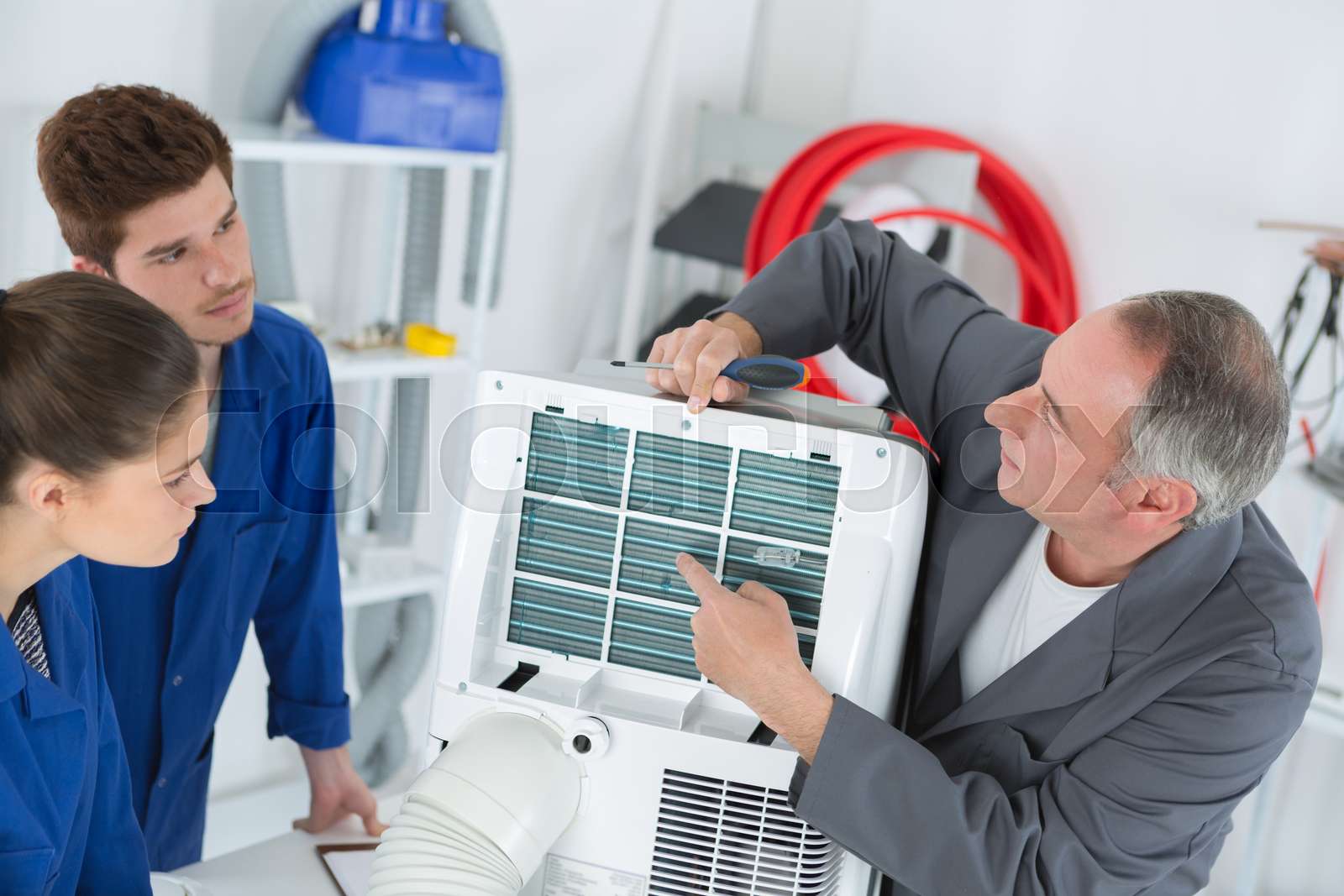 young students learning to adjust air conditioning system | Stock image ...