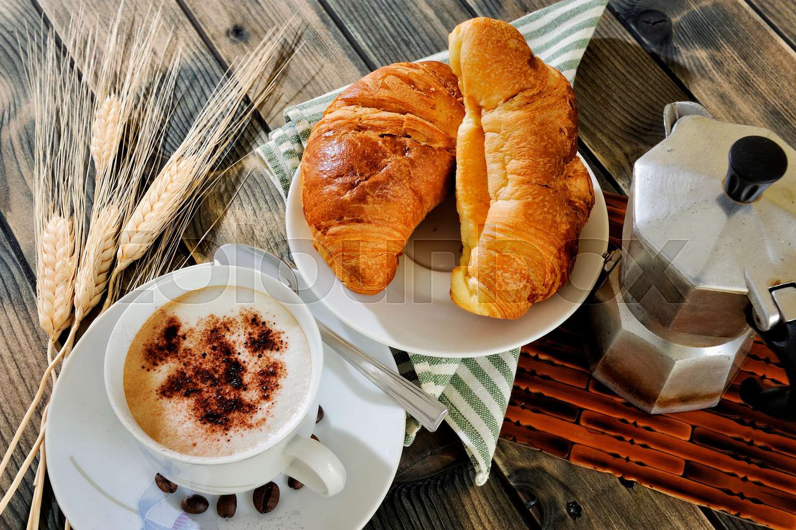 Traditional Italian breakfast with cappuccino and croissants on a ...