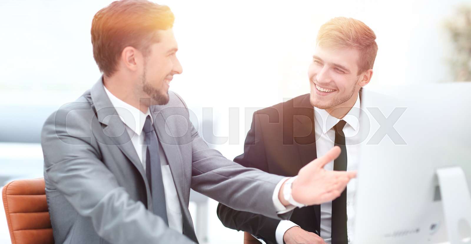 employees are talking sitting behind a Desk | Stock image | Colourbox