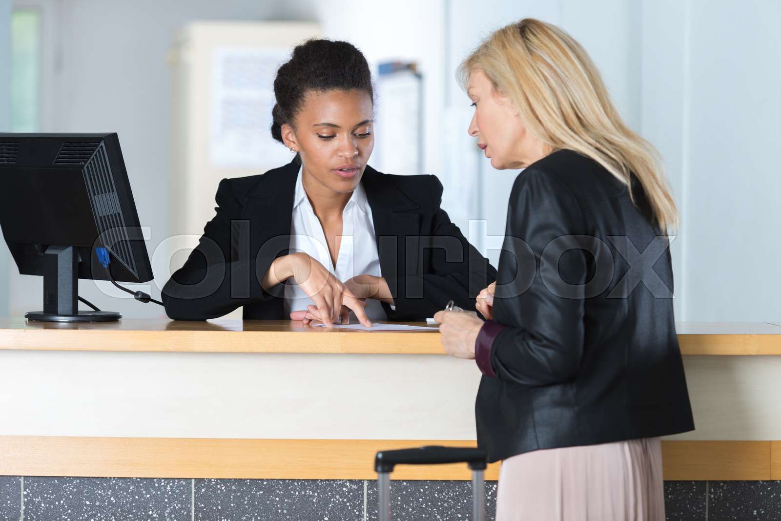 hostess and guest communicate with each other | Stock image | Colourbox