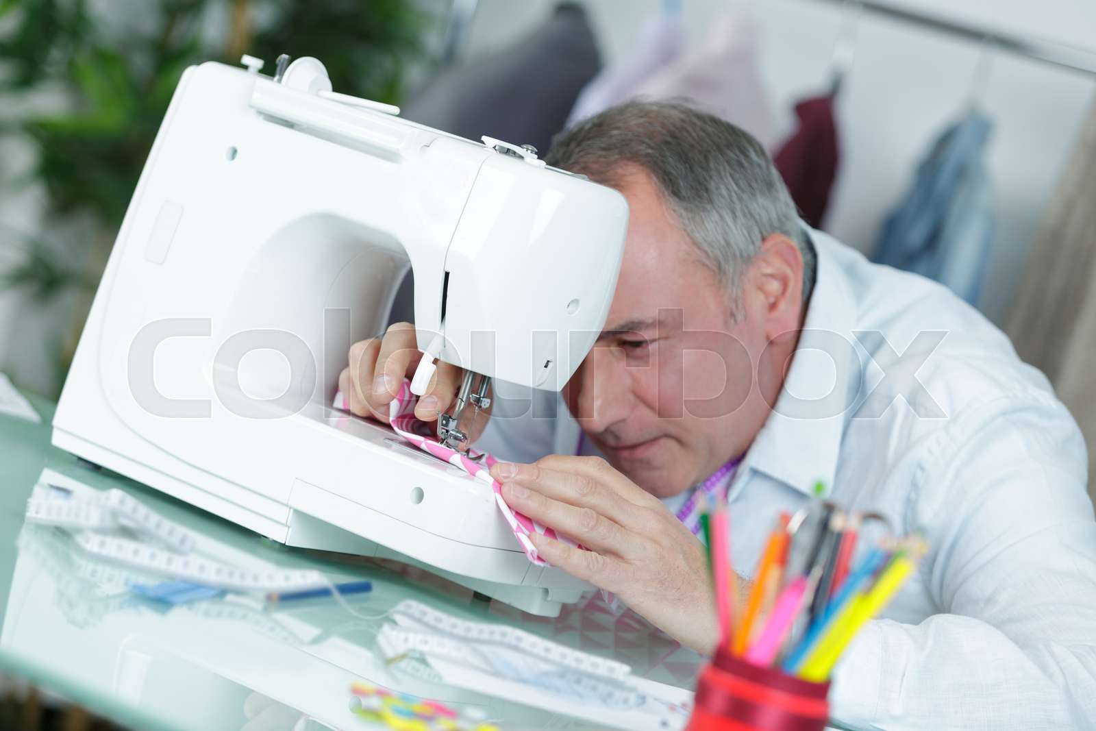 tailor with sewing machine | Stock image | Colourbox