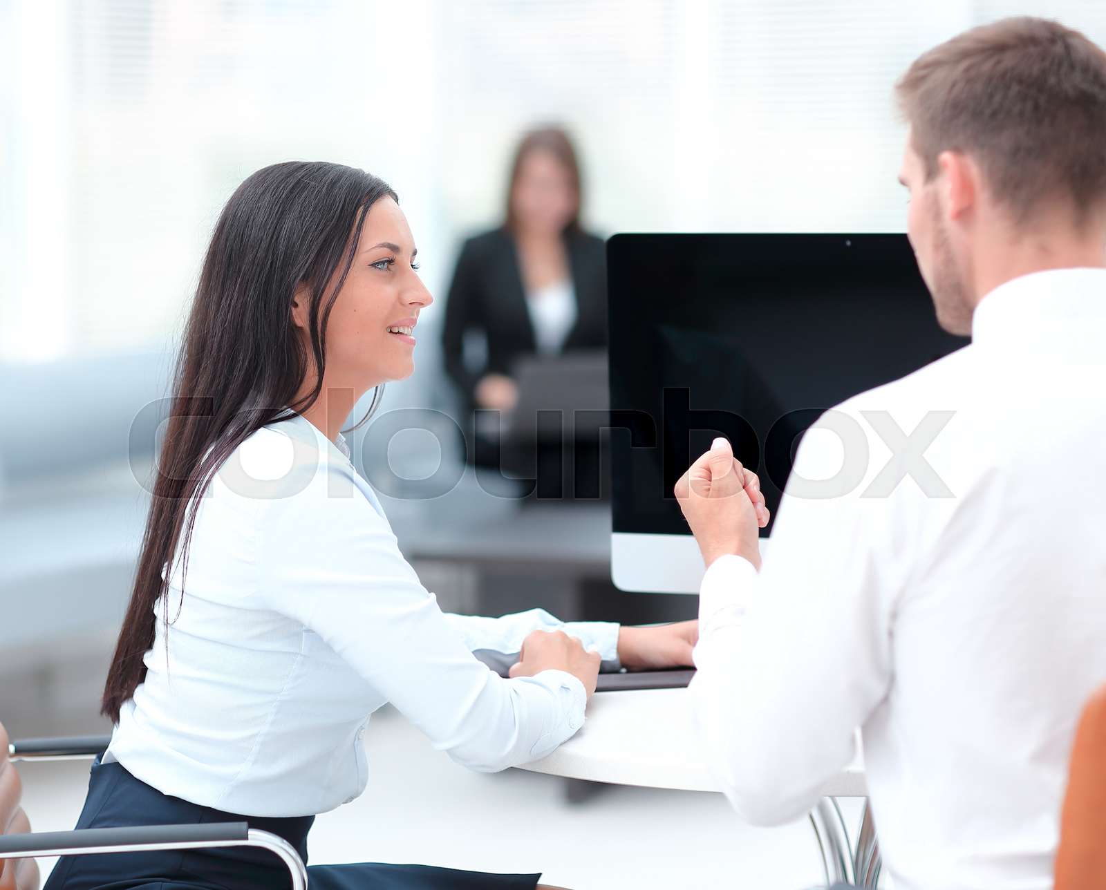 two successful employee talking sitting behind a Desk | Stock image ...