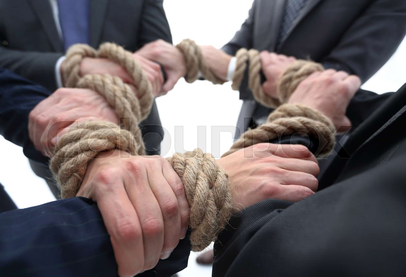 closeup.Hands holding rope forming a circle | Stock image | Colourbox