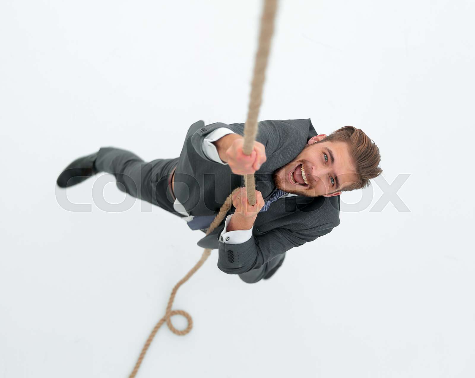 successful businessman climbing the rope | Stock image | Colourbox