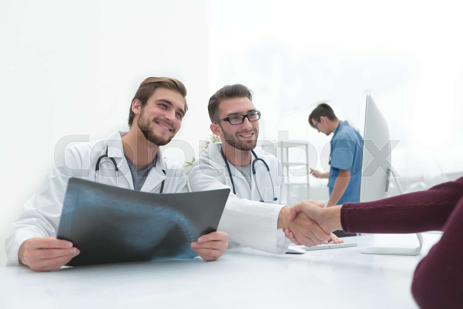 group of doctors welcoming their customer with a handshake | Stock ...