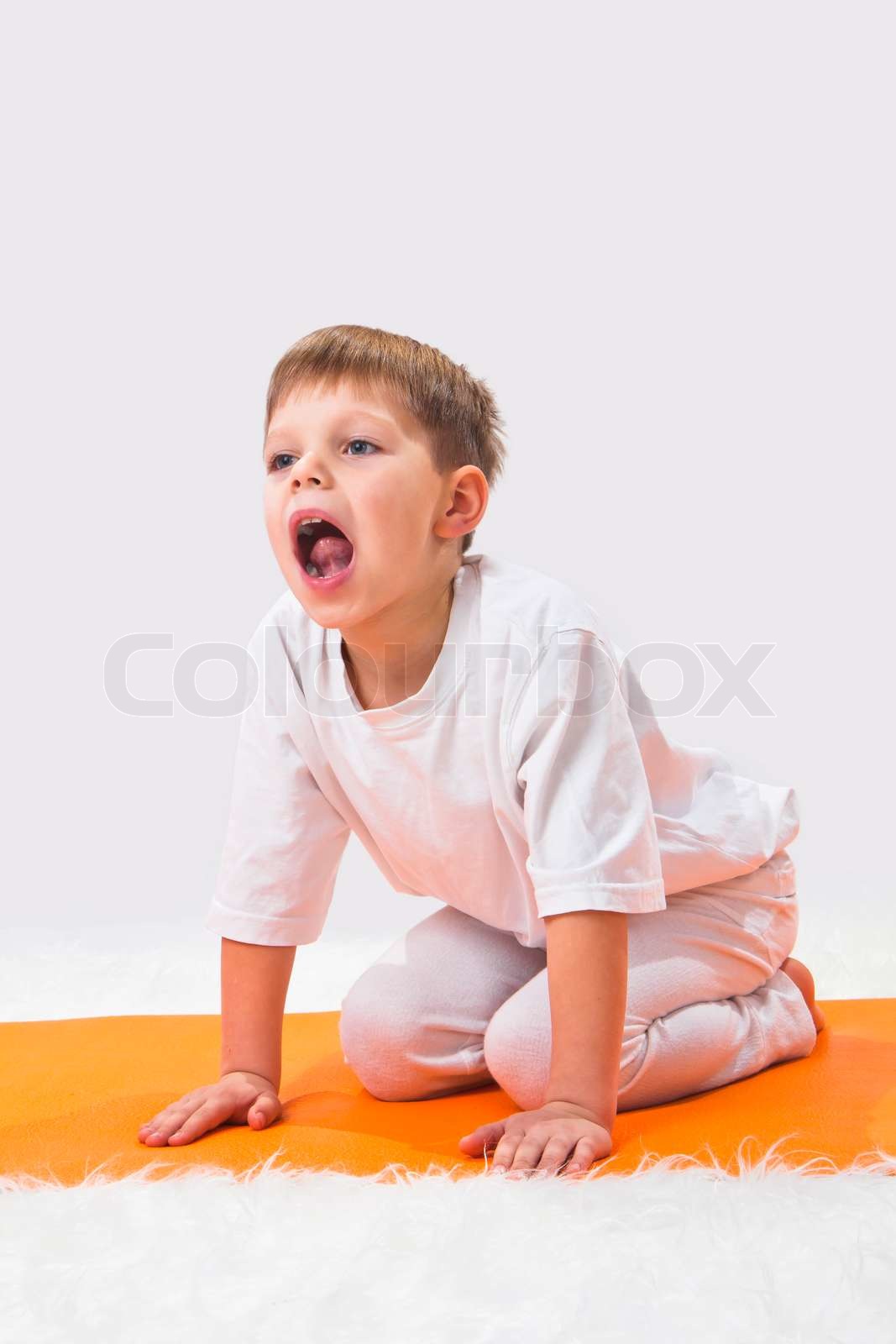 The little boy does exercise | Stock image | Colourbox