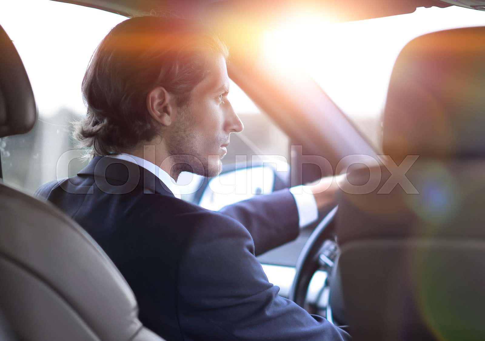 successful man sitting behind the wheel of a car | Stock image | Colourbox