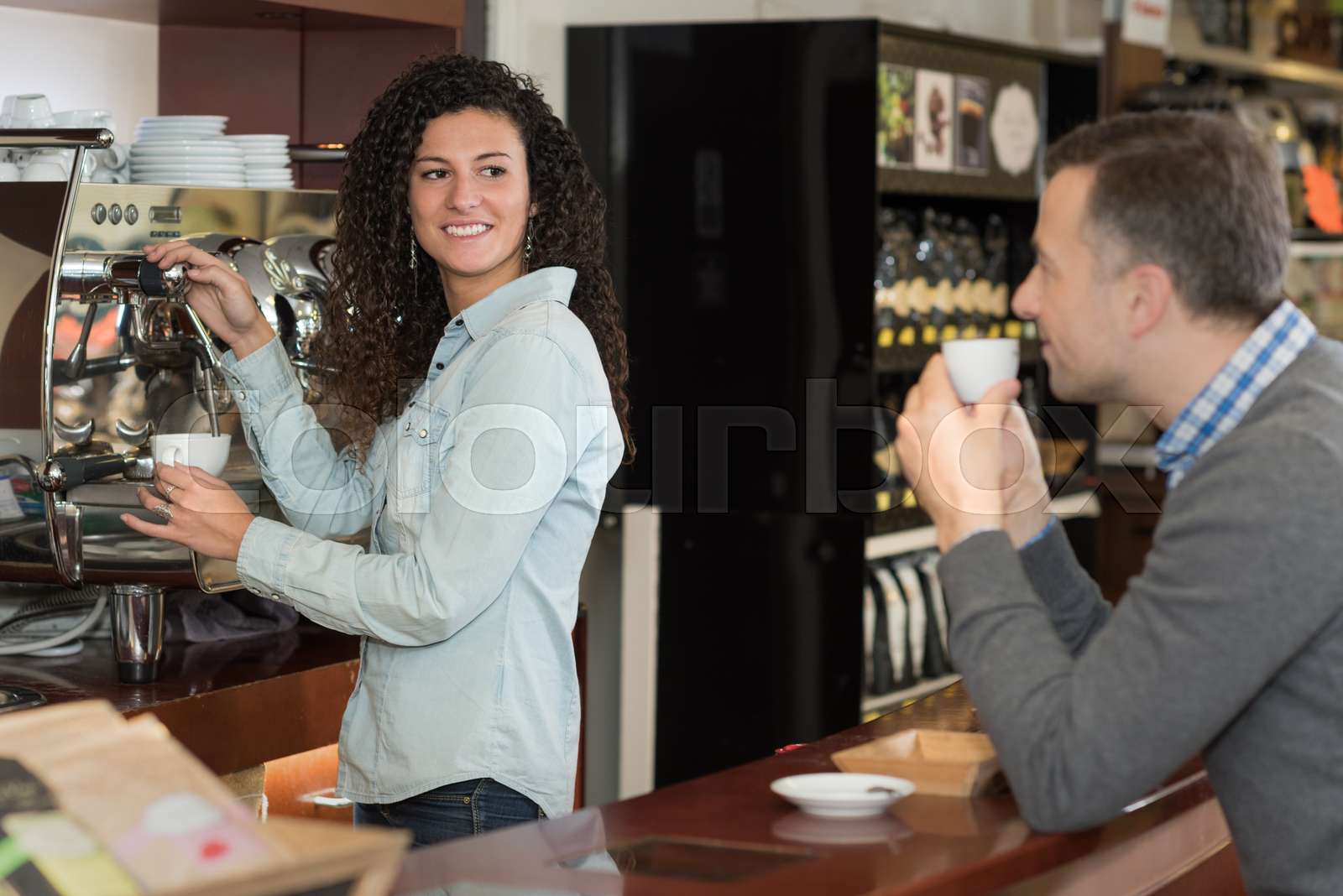 Woman serving coffee in cafe | Stock image | Colourbox
