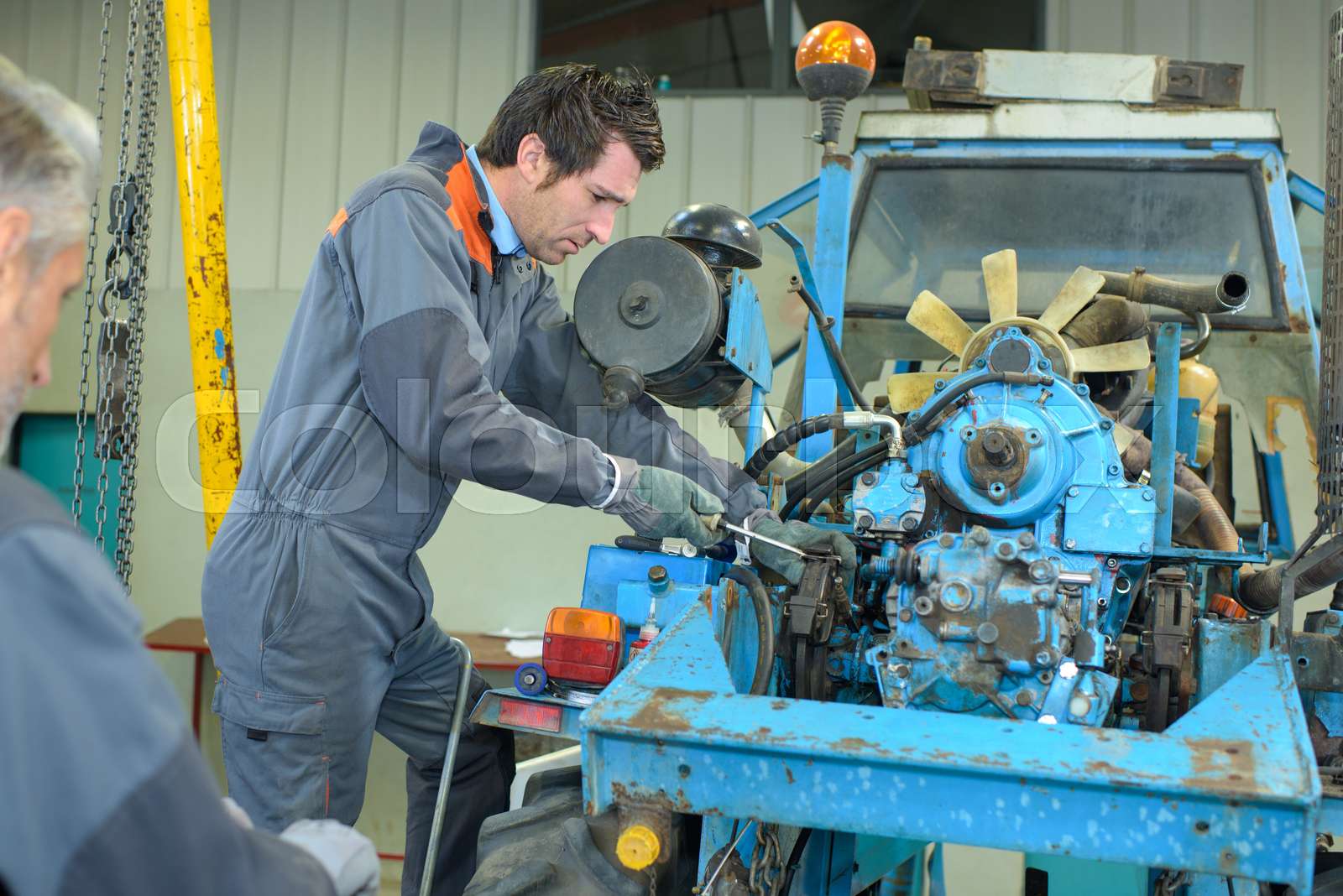 Man working on tractor | Stock image | Colourbox