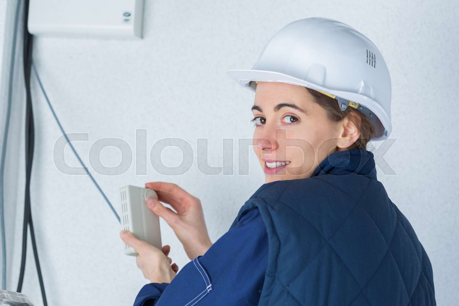 Portrait of female electrician at work | Stock image | Colourbox
