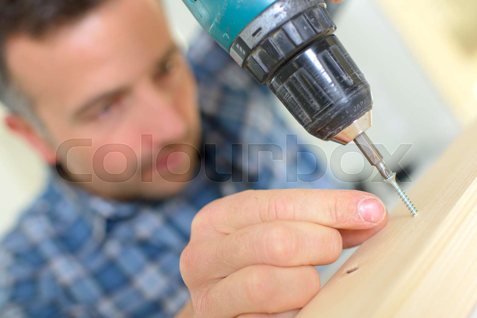 Man using an electric screwdriver | Stock image | Colourbox
