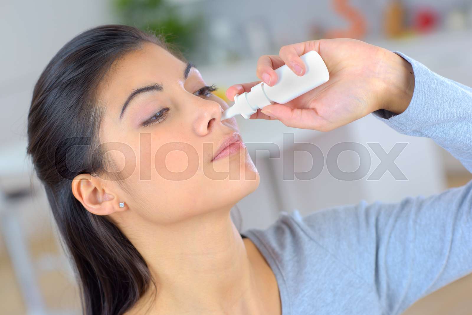 girl taking nose medicine | Stock image | Colourbox