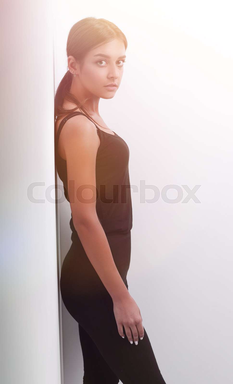 modern young woman leaning on wall | Stock image | Colourbox