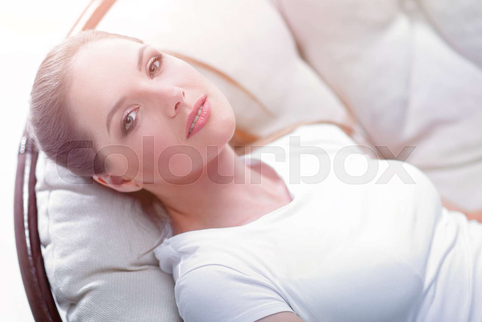 tired woman resting in an easy chair made of rattan | Stock image ...