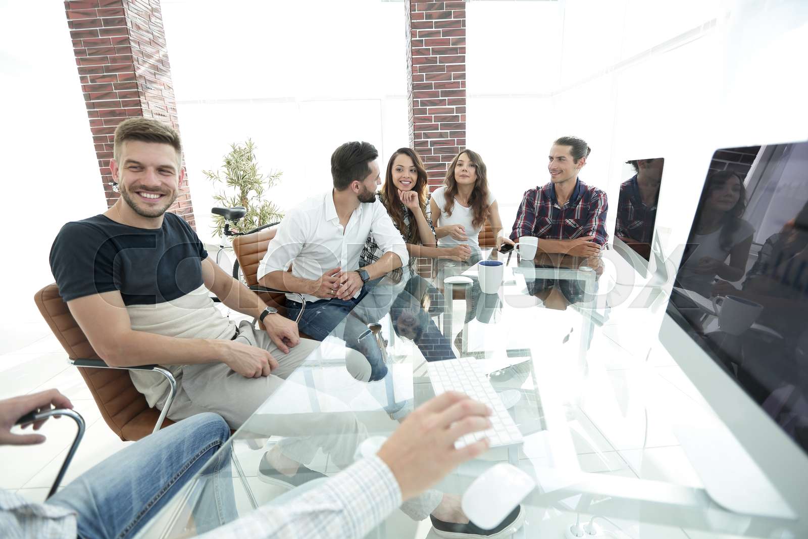 business team sitting at a modern Desk. | Stock image | Colourbox