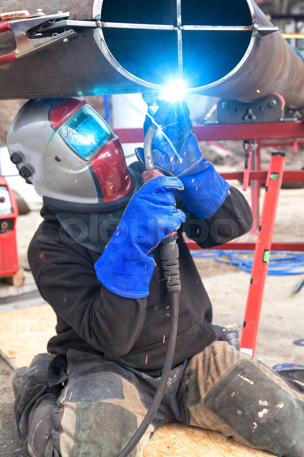 Worker welding in a factory. Welding on an industrial plant. | Stock ...