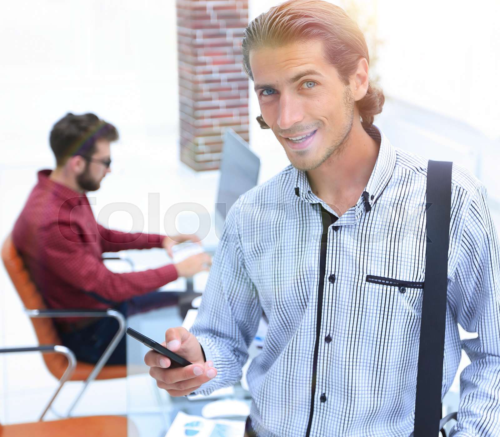young employee standing in the office | Stock image | Colourbox
