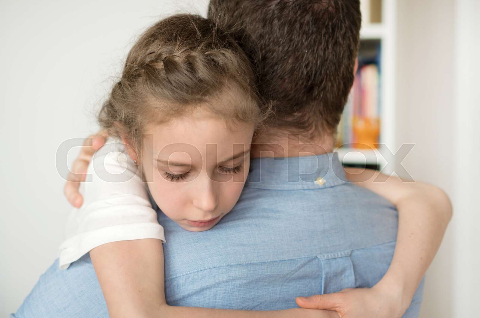 Sad little girl hugging her dad. | Stock image | Colourbox